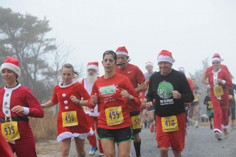 A saturated Santa 5K runs through fog at Cape Henlopen State Park ...